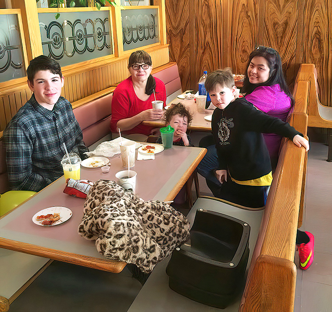 The family booth at Joe's—where memories are made between bites and napkin usage reaches Olympic levels.