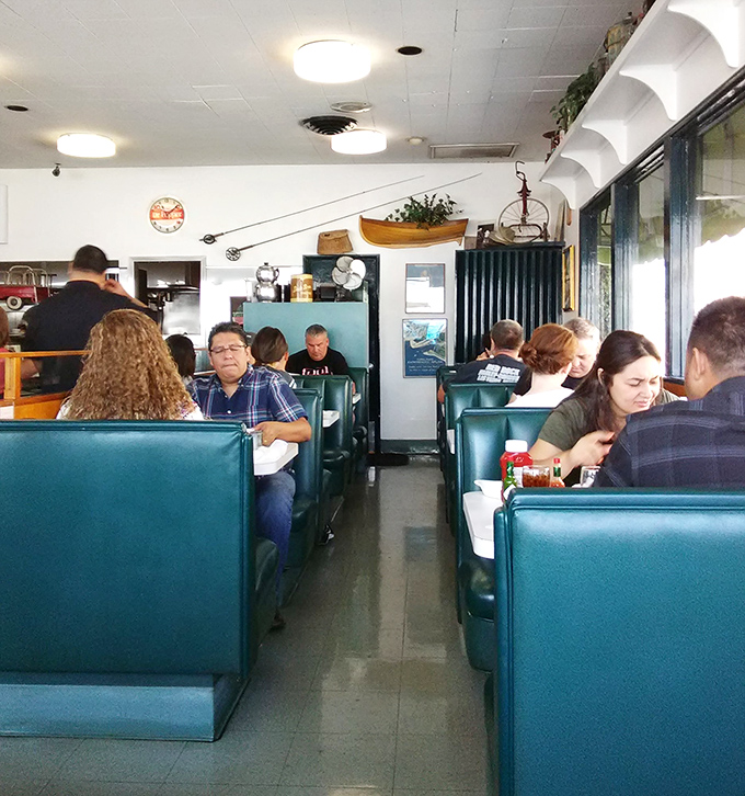 Classic diner booths in that perfect shade of teal—where strangers become neighbors and everyone's united by the universal language of good food.