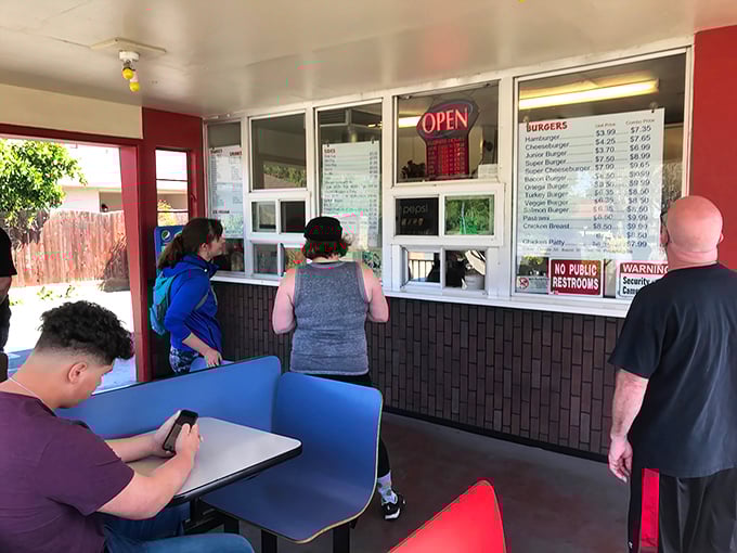 The lunch rush at Snowhite isn't just about eating—it's a community ritual where all social barriers dissolve in pursuit of burger bliss.