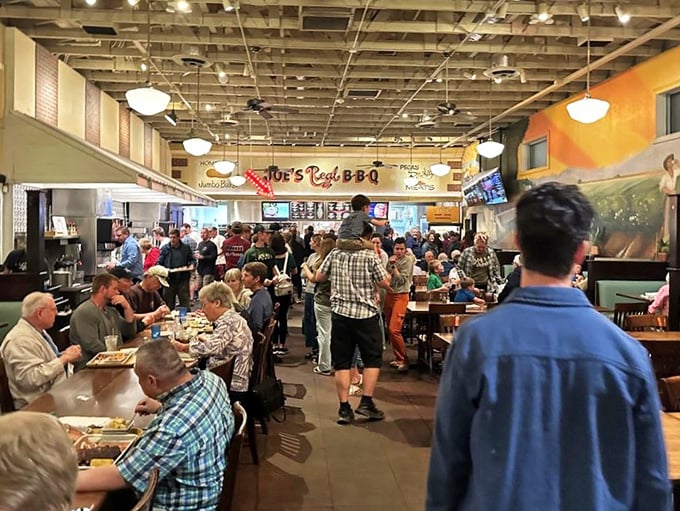 The bustling dining room is democracy in action—everyone from cowboys to computer programmers united by the universal language of great barbecue.