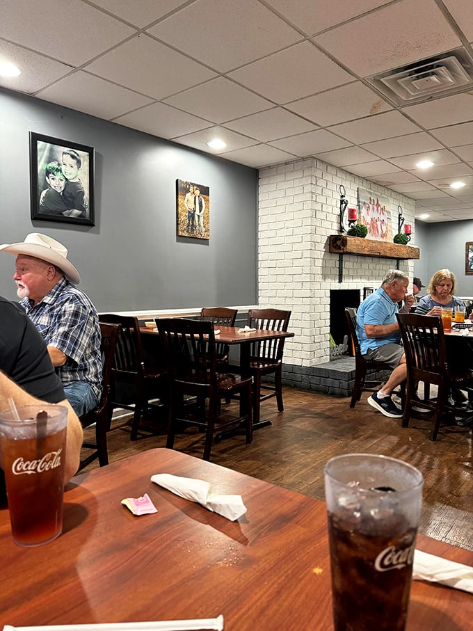 The dining room hums with conversation while Coca-Cola flows freely – the soundtrack and fuel of authentic Southern dining experiences.