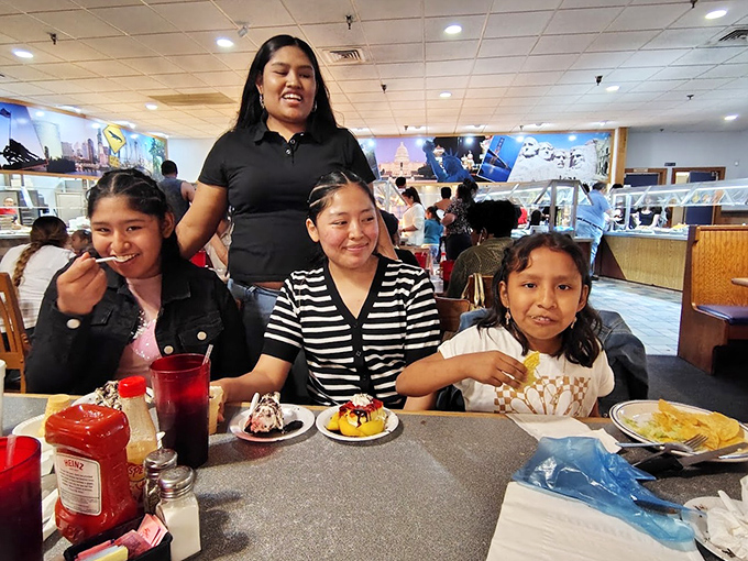 Families making memories over multiple plates—the true American dream involves dessert with your name on it.