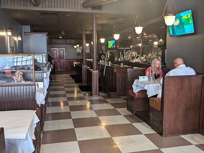The dining room during service—where strangers become friends over shared food recommendations. That checkerboard floor has witnessed countless "you HAVE to try this" moments.