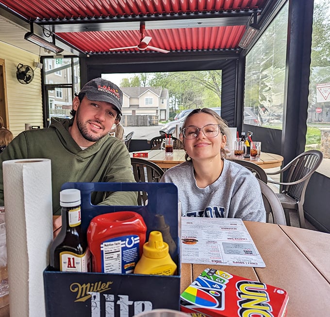 The covered patio at Bub's—where condiment caddies and conversation flow freely among burger enthusiasts.