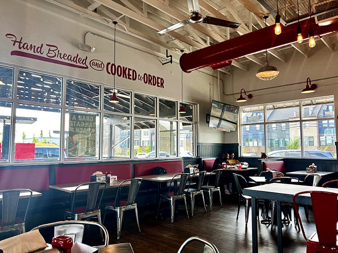 "Hand Breaded and Cooked to Order" isn't just wall decoration—it's the restaurant's mission statement spelled out above diners enjoying the fruits of that promise.
