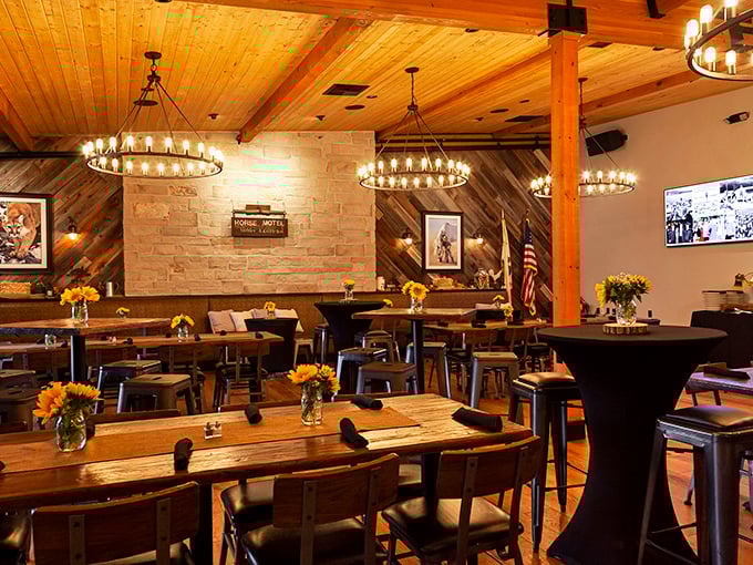 Rustic elegance with wooden beams and circular chandeliers. Even the sunflowers seem to be celebrating what's about to happen on those tables.