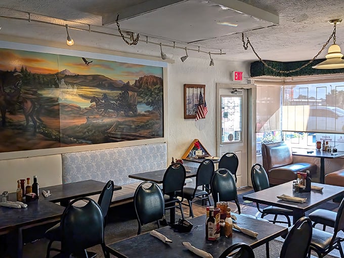 Murals of wilderness scenes watch over diners like guardians of carnivorous tradition. These tables have hosted countless celebrations and everyday victories.