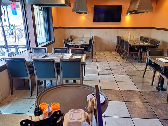 The dining room balances functionality with warmth—each table equipped with its own grill, ready for the meat parade to begin.
