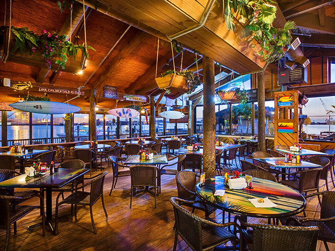 Warm wood tones, strategic lighting, and water views that could make a landlocked tourist weep with joy. Dining rooms like this are why Florida exists. 