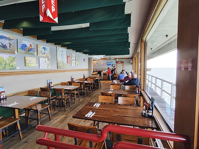 The dining room's wooden simplicity lets the panoramic ocean views take center stage—nature's television better than any streaming service.