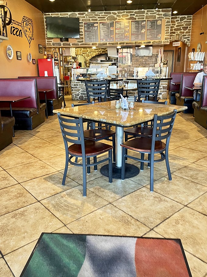 The dining area says "stay awhile" with its cozy booths and Italian flag welcome mat—comfort before the comfort food.