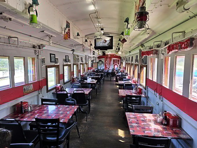 The full dining car experience—narrow, nostalgic, and perfectly preserved. Those red-checkered tablecloths aren't just decoration; they're time machines to simpler days.