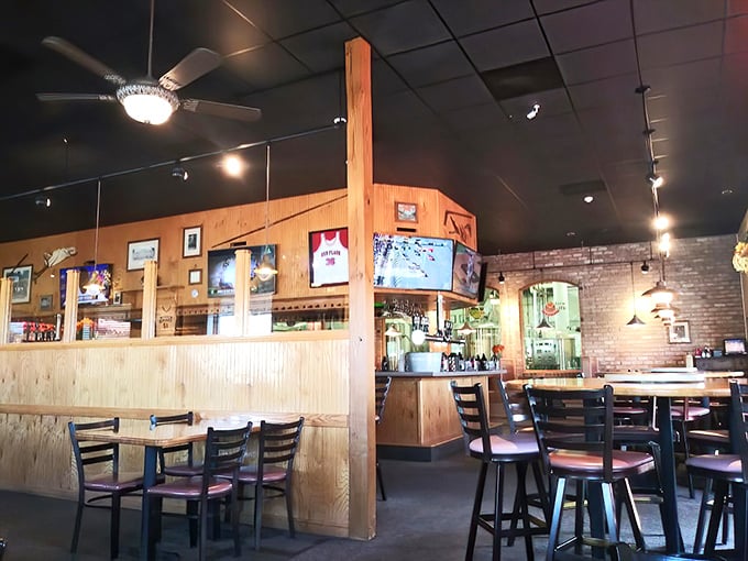 The dining area speaks the universal language of comfort. Wood paneling and sturdy chairs say, "Stay awhile, order dessert, have another round."