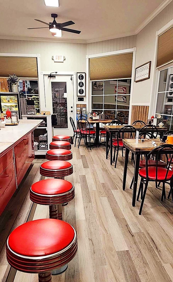 Classic diner aesthetics with those iconic red counter stools lined up like soldiers ready for the breakfast rush. Norman Rockwell would approve.