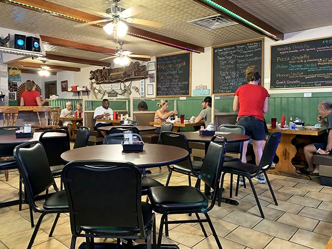 Green wainscoting, chalkboard specials, and ceiling fans spinning stories overhead—this dining room has hosted more morning revelations than a therapist's office.