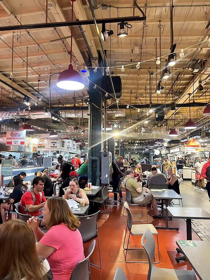 Reading Terminal Market's communal dining area buzzes with the energy of food lovers. String lights overhead add a touch of magic to this culinary playground.