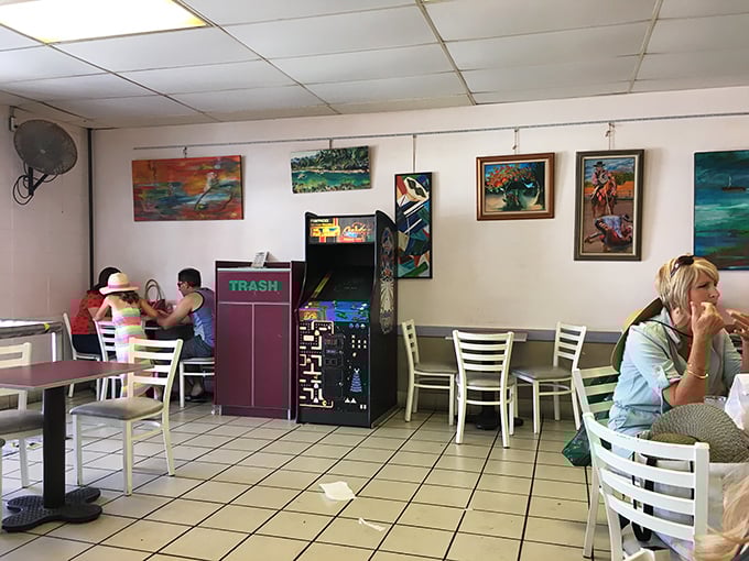 The dining area: where strangers become friends united by sticky fingers and sugar-induced grins. Note the vintage arcade game—dessert and entertainment!