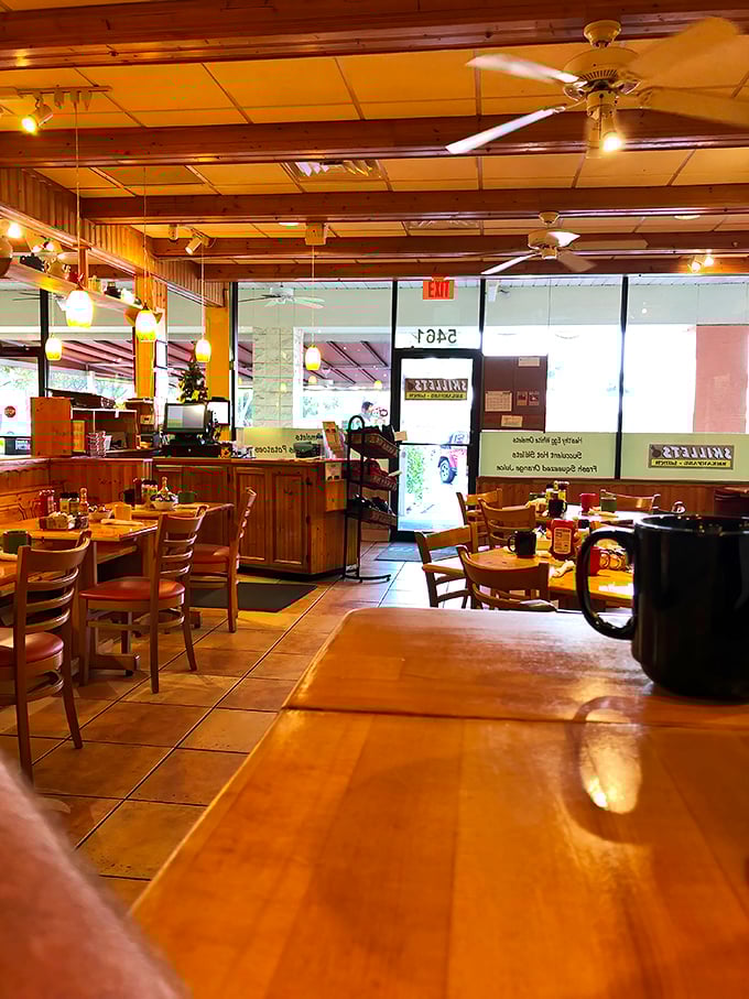 The dining area balances rustic charm with clean simplicity. Those ceiling fans keep the Florida heat at bay while you focus on the important stuff – eating.