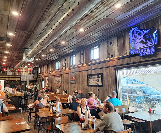 The dining area where strangers become friends over plates of comfort food. That railroad crossing sign isn't just decor—it's a warning to diet plans.