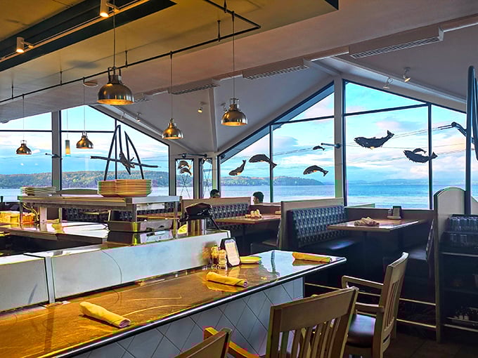 Dining with a view that makes you forget your phone exists. Those fish silhouettes swimming across the windows are a delightful touch of whimsy.