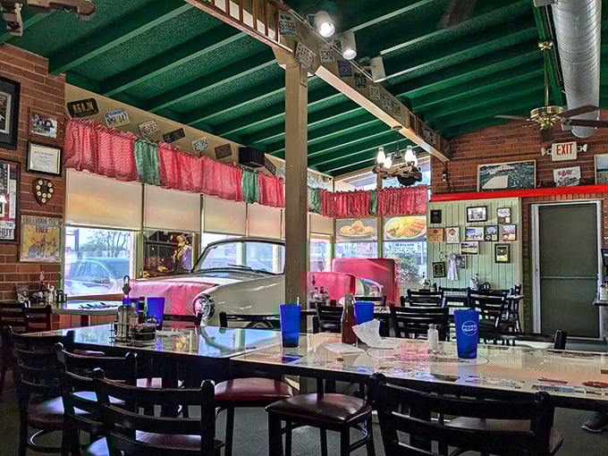 Red curtains, yellow tables, and that signature green ceiling—dining here feels like being inside a Norman Rockwell painting with better food.