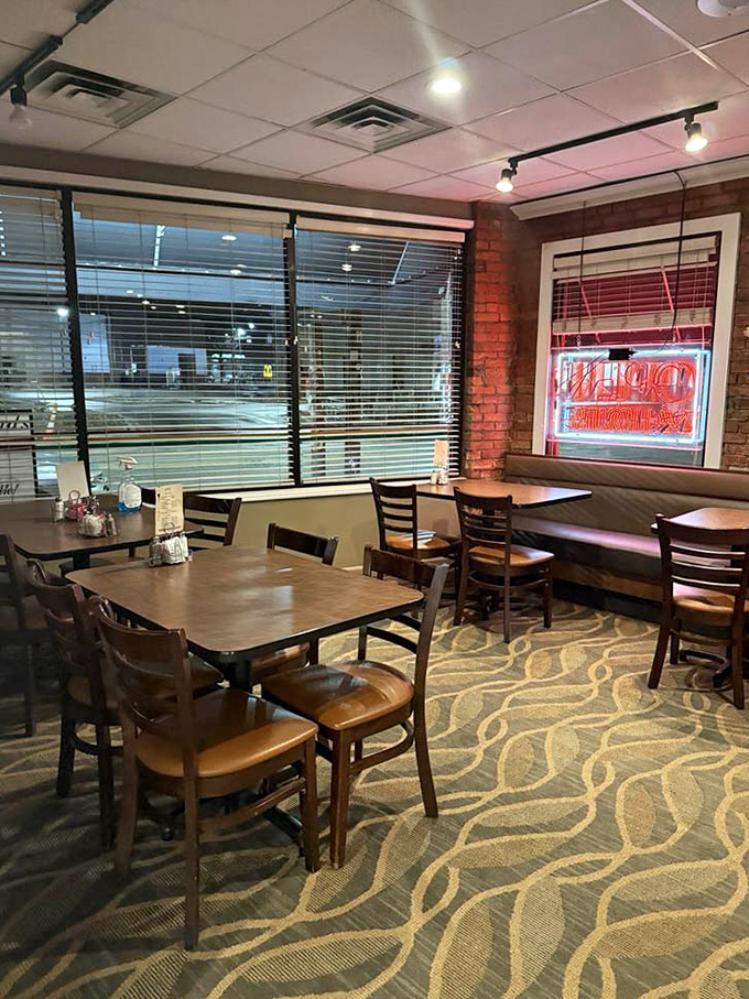 Evening light transforms the dining area into a cozy retreat, where those wooden chairs practically whisper, "Stay for dessert."
