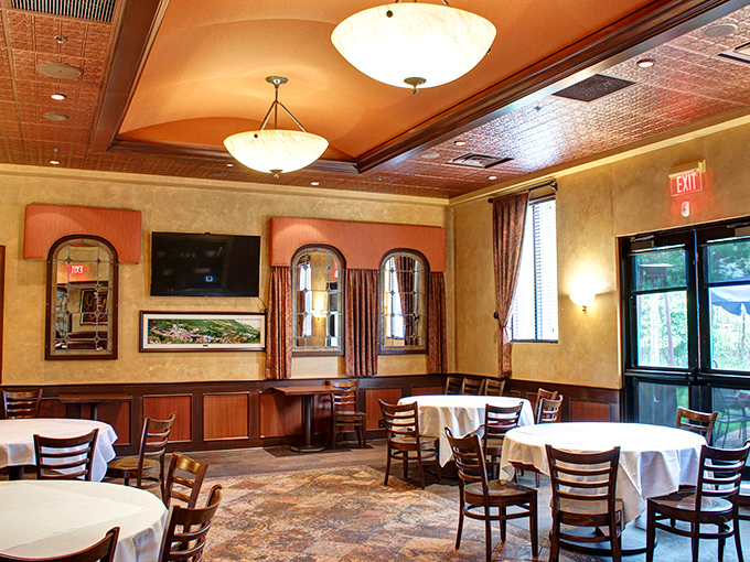 This dining area's textured ceiling, soft lighting, and elegant table settings create an atmosphere where you'll want to linger over that last glass of wine.