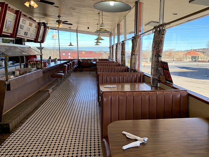 The classic diner layout – where every booth tells a story and the counter stools have supported generations of road-weary travelers.