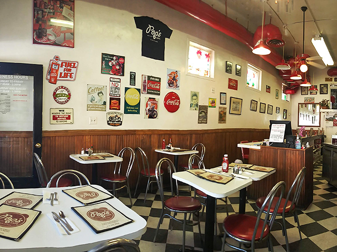The dining area speaks volumes without saying a word—vintage signs, red accents, and tables that have hosted thousands of morning conversations.