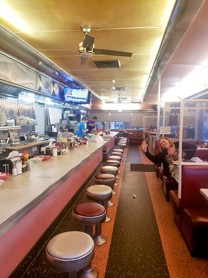 The classic diner layout—counter on one side, booths on the other—creating the perfect ecosystem for coffee refills and conversations that matter.