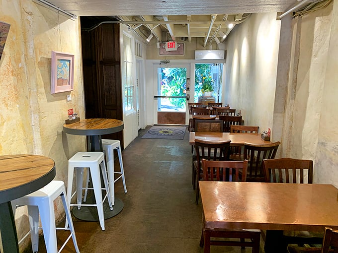 The dining area feels like that cool friend's apartment—minimalist yet inviting. Wooden tables, concrete floors, and walls that let the food be the star.