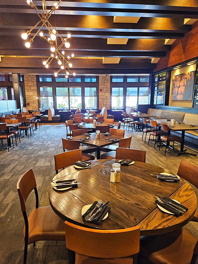 Modern chandeliers cast a warm glow over tables set with anticipation. The dining room feels like someone's very stylish living room – if that someone really loved wine.