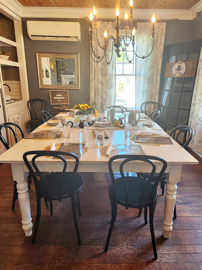 Elegant simplicity defines this dining space—where chandelier lighting, white linens, and farmhouse charm create the perfect backdrop for breakfast magic to unfold.