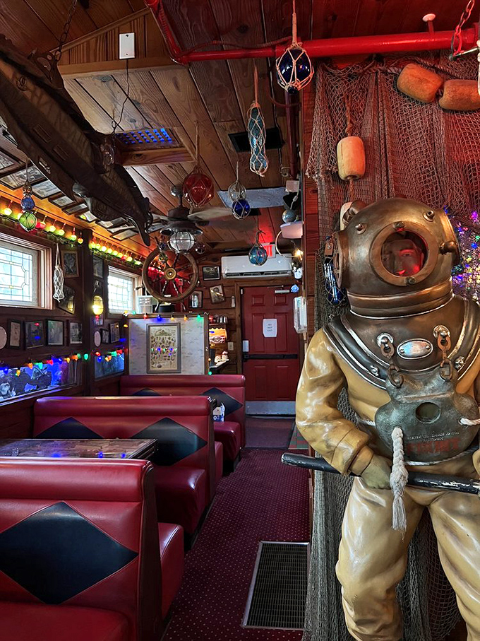 Nautical whimsy meets retro diner vibes in this dining area, complete with vintage diving suit standing guard over your meal.
