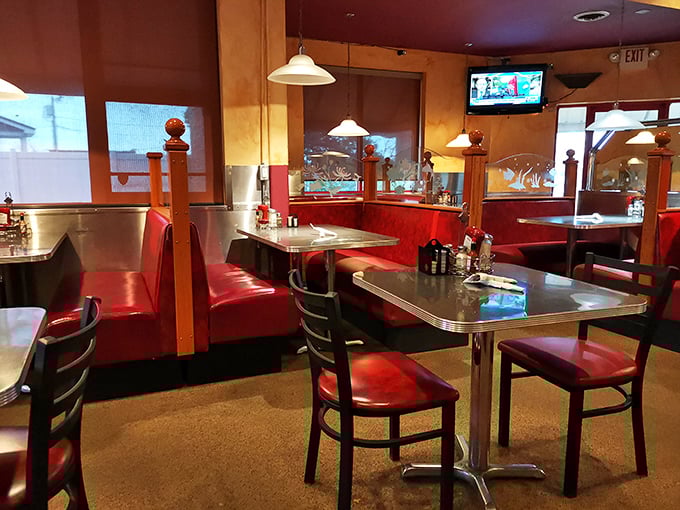 The warm glow of pendant lights transforms simple tables into intimate dining spots where conversations flow as freely as coffee.