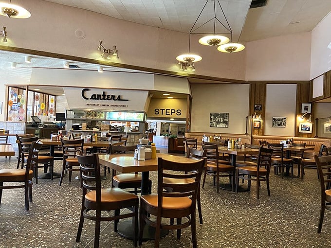 The dining room where celebrities and night owls share the same terrazzo floor. Democracy tastes like pastrami at 3 AM.