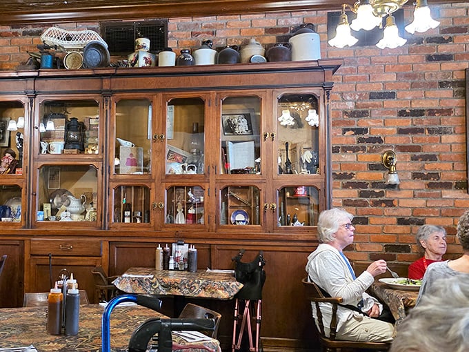 Vintage cabinets filled with curiosities create a homey backdrop that makes every meal feel like Sunday dinner at grandma's—if grandma smoked meat.