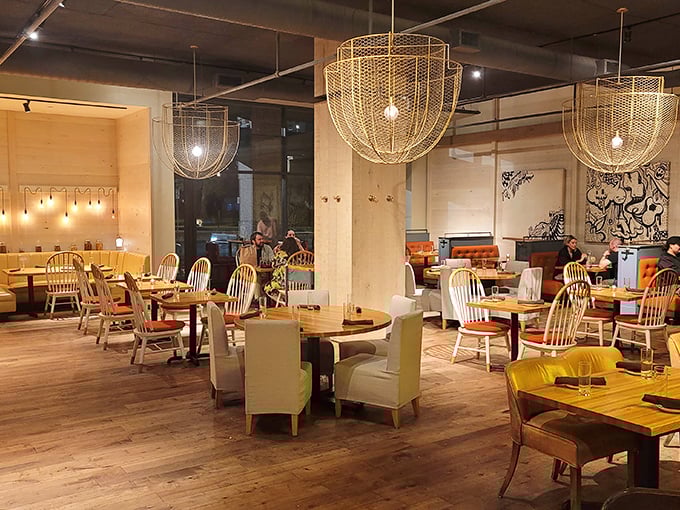 Warm wood tones and elegant cage lighting create an atmosphere where comfort meets sophistication—like your favorite jeans paired with a tailored jacket.