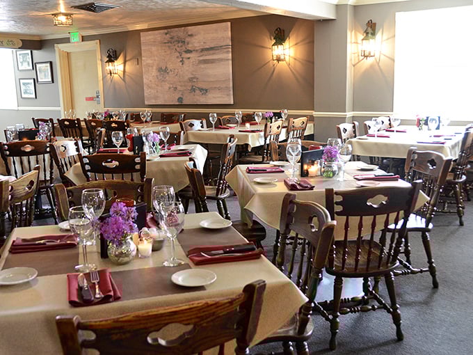 The dining room at Schwarz's isn't just arranged—it's choreographed. White tablecloths and wooden chairs create that perfect "special but comfortable" vibe.
