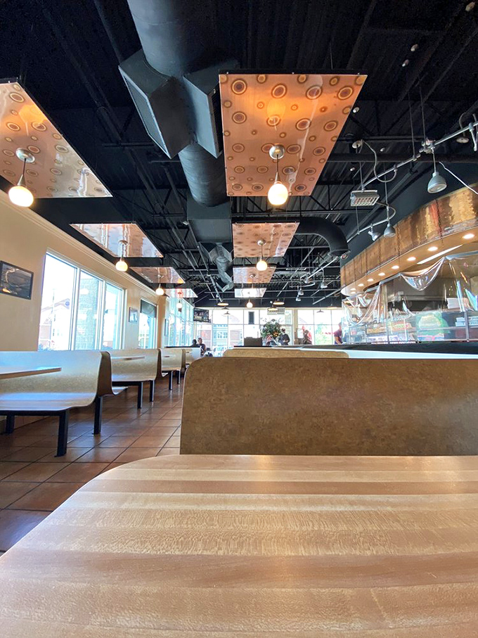 The dining area's copper and wood elements create an atmosphere that says, "Stay awhile, have another slice."