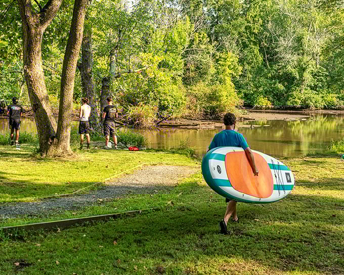 At Douglas Nichols Park, paddleboarding enthusiasts and fishing aficionados share the peaceful waters in a delicate dance of recreational harmony.