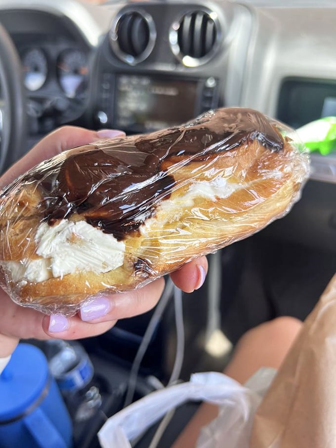 The road trip pastry of champions—a cream-filled eclair that transforms any car dashboard into a five-star dining experience. 