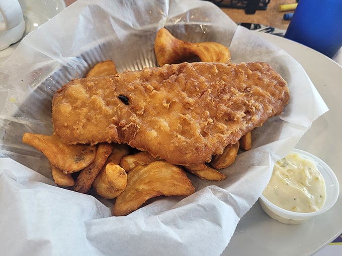 Fish and chips that would make the British jealous—golden, crispy batter protecting flaky white fish. The tartar sauce is just the beginning of a beautiful friendship.