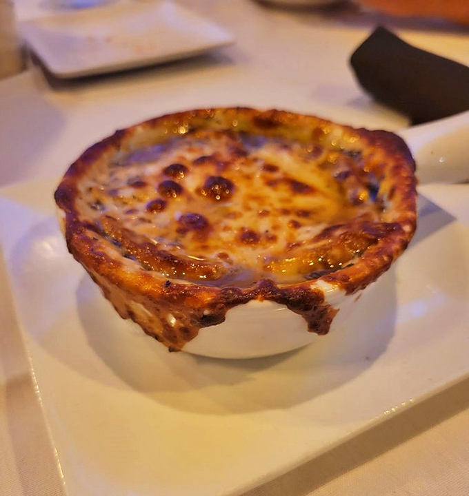 French onion soup with a cheese pull that deserves its own standing ovation – bubbling, golden, and gloriously excessive.