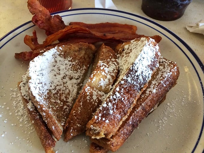 French toast dusted with powdered sugar and accompanied by bacon - dessert masquerading as breakfast, and nobody's complaining.
