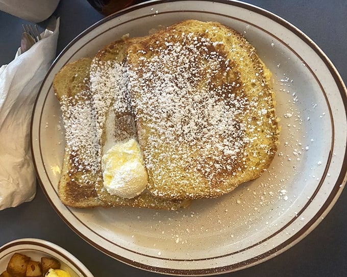 French toast so perfectly golden and powdered, it's the breakfast equivalent of finding front-row concert tickets in your coat pocket.
