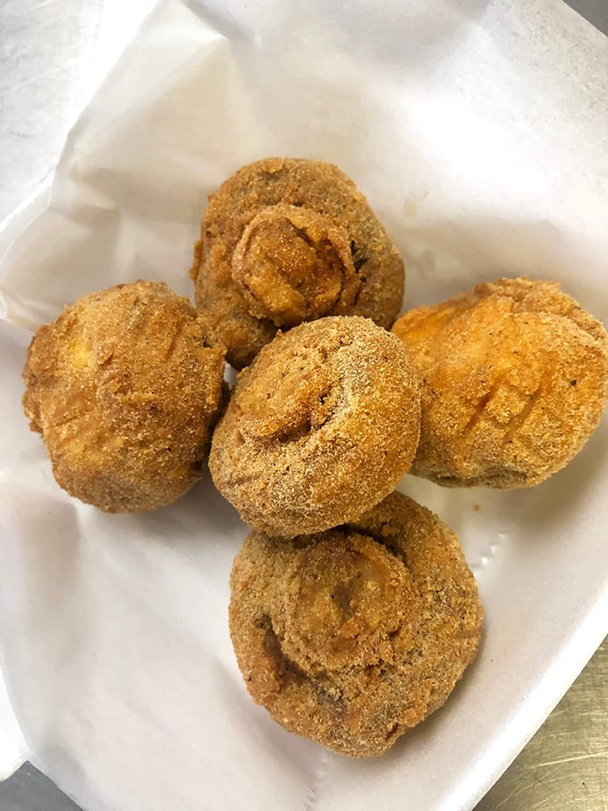 These aren't your average mushrooms—they're little umami bombs, transformed through the magical alchemy of perfect breading and hot oil into addictive bites.