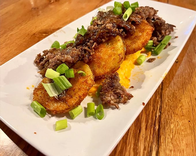 Fried green tomatoes topped with mysterious deliciousness – sometimes the best discoveries come from adventurous menu choices.