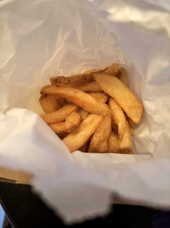 These aren't just fries—they're golden potato wands of happiness, nestled in paper like the simple treasure they are.