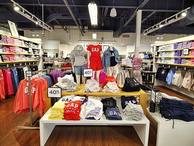 GAP's color-coded kingdom where folded t-shirts create a landscape of possibility. Those 40% off signs are the retail equivalent of a siren's call.